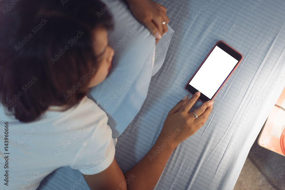 Asian women are using the blank screen smart phone on the bed before ...