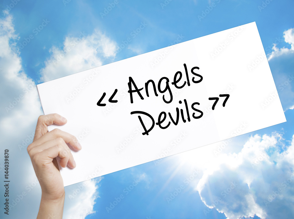 Angels - Devils Sign on white paper. Man Hand Holding Paper with text ...