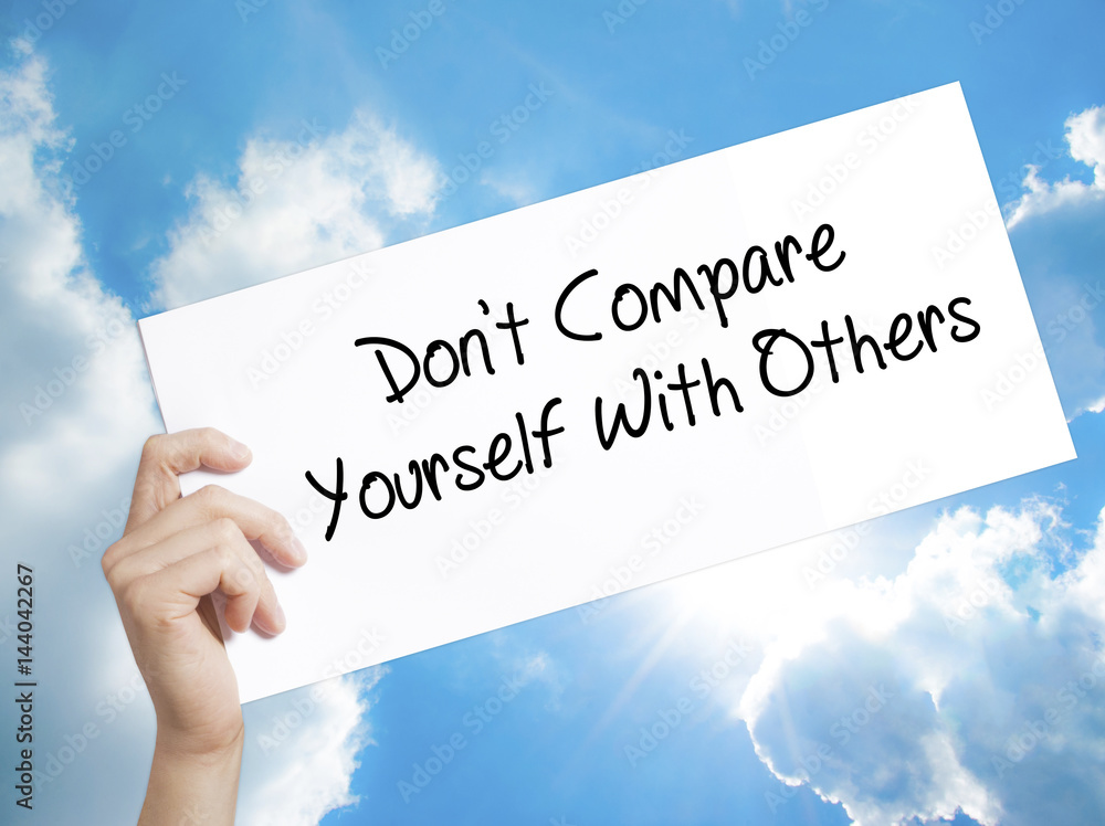 Don't Compare Yourself With Others Sign on white paper. Man Hand ...