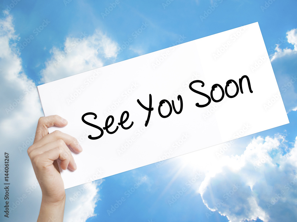 See You Soon Sign on white paper. Man Hand Holding Paper with text ...