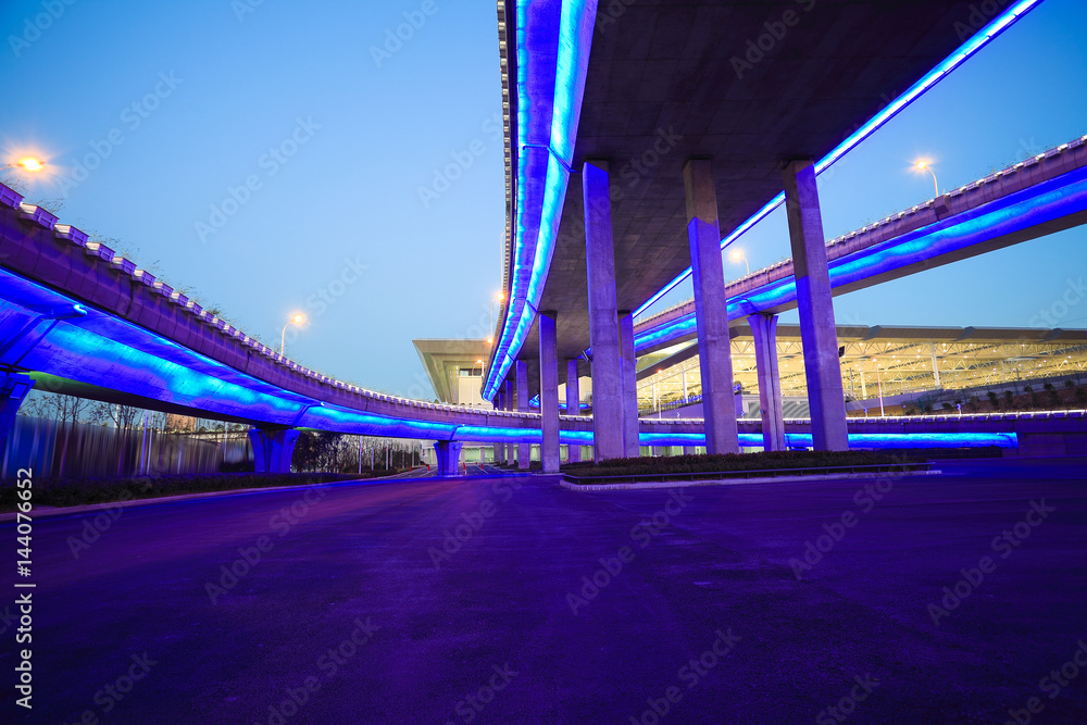 Empty road floor with city viaduct bridge of neon lights night Stock ...