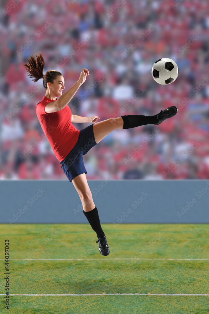 Female Soccer Player Kicking Ball Stock Photo | Adobe Stock