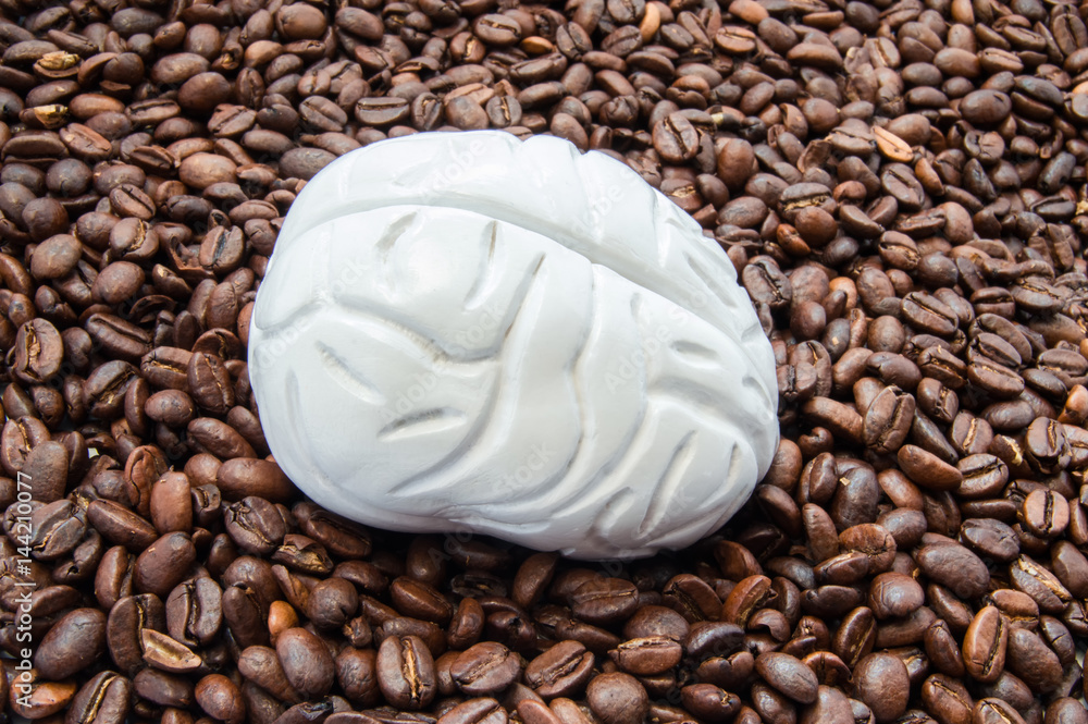 Brain and coffee (caffeine). Brain model is among coffee beans ...
