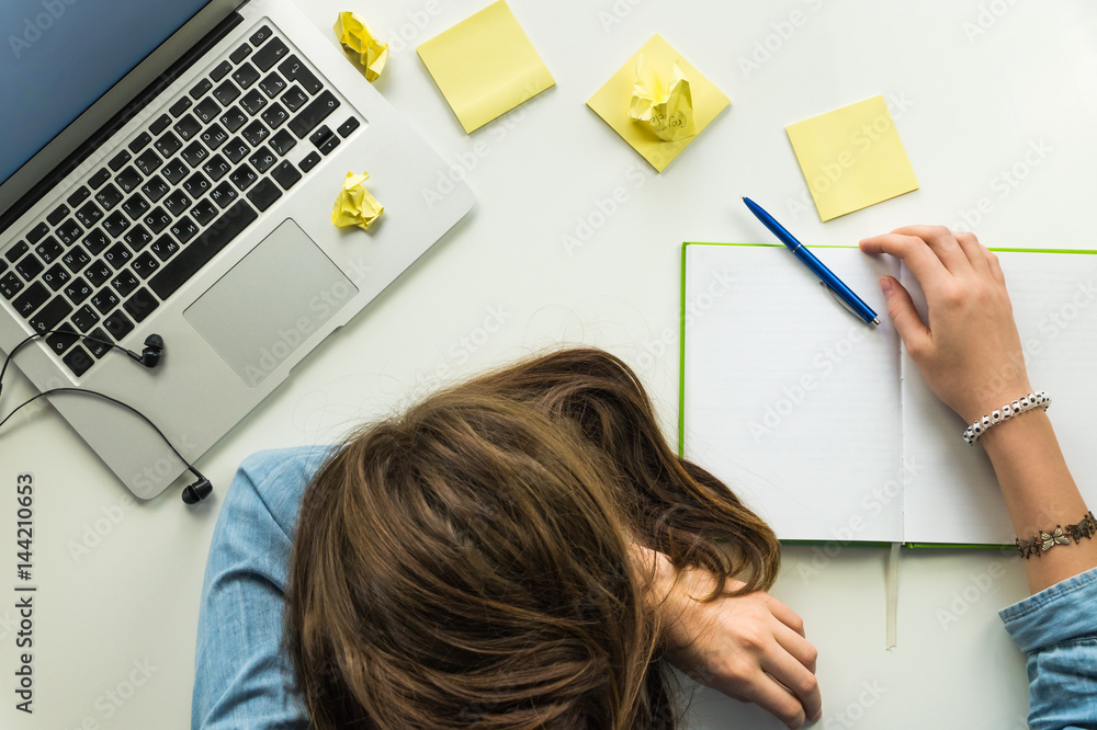 Tired person at home office desk top view. Head of female human resting ...