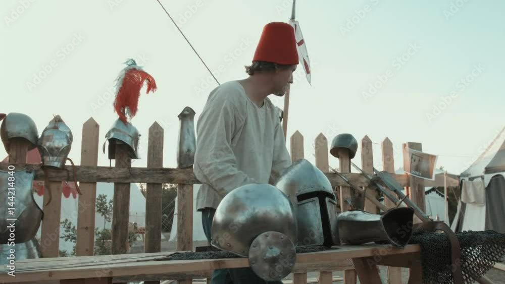 Medieval master rubbing iron armor, helmets and swords Stock Video ...