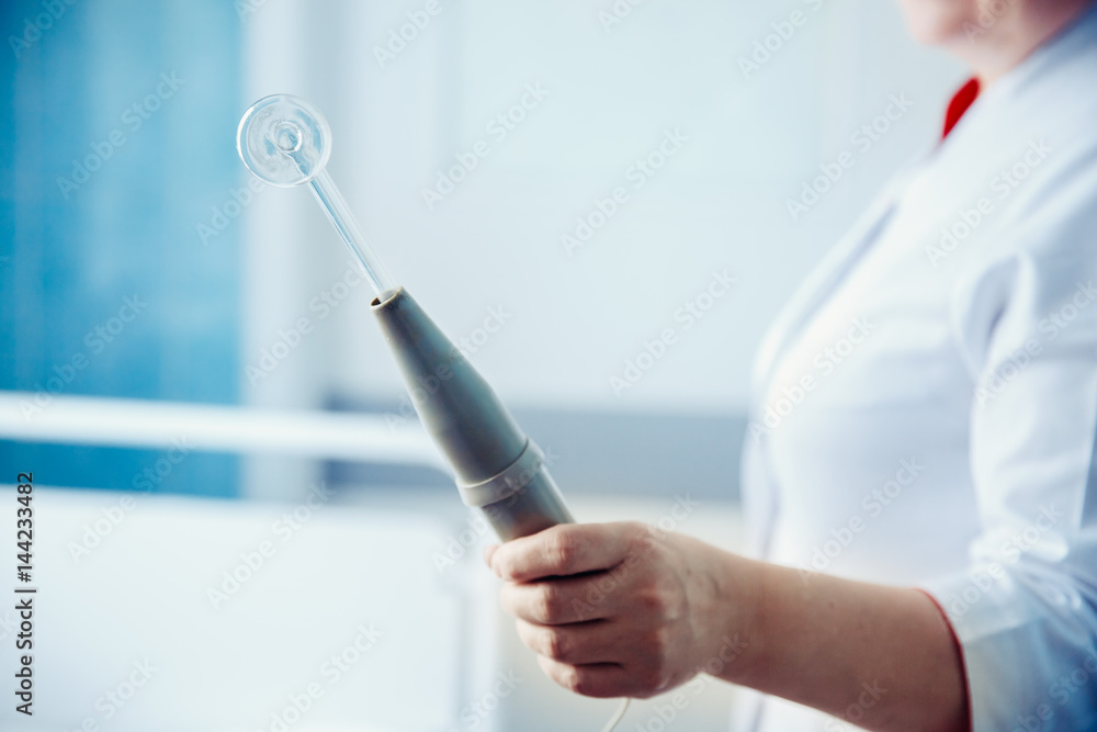 Nurse holds an apparatus for the treatment of electric shock Darsonval ...