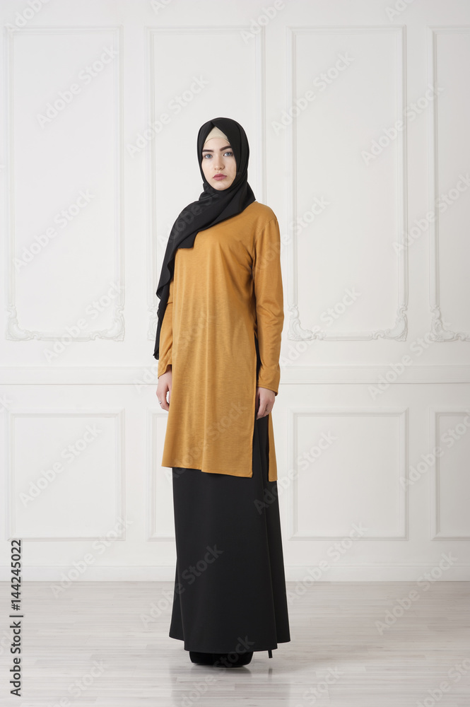 Beautiful Islamic girl in a closed, traditional Muslim dress, a studio ...
