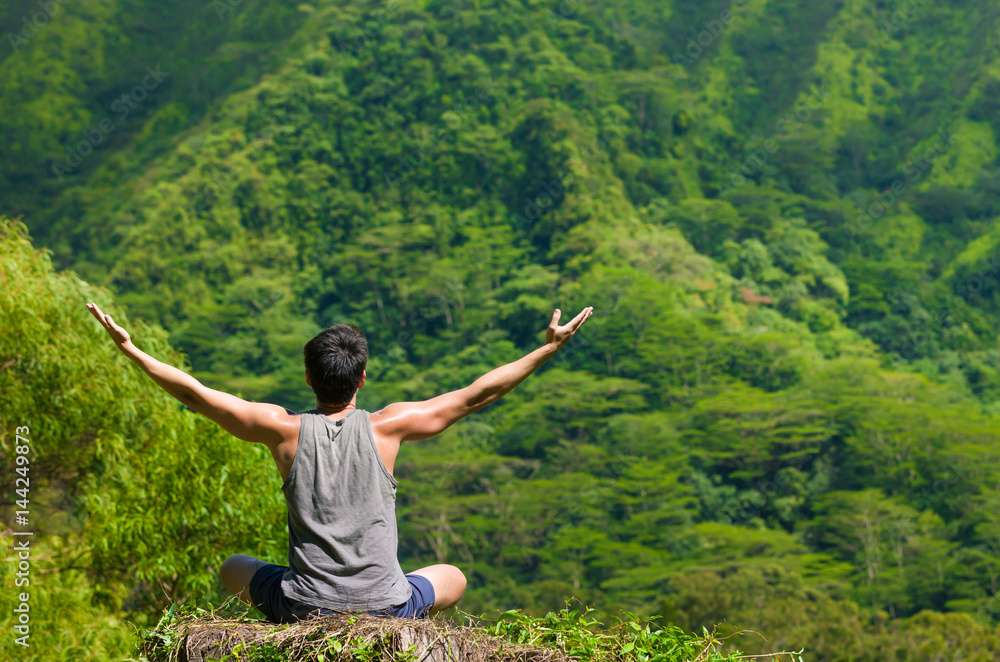 Happiness and freedom concept. Man in a meditation pose celebrating ...