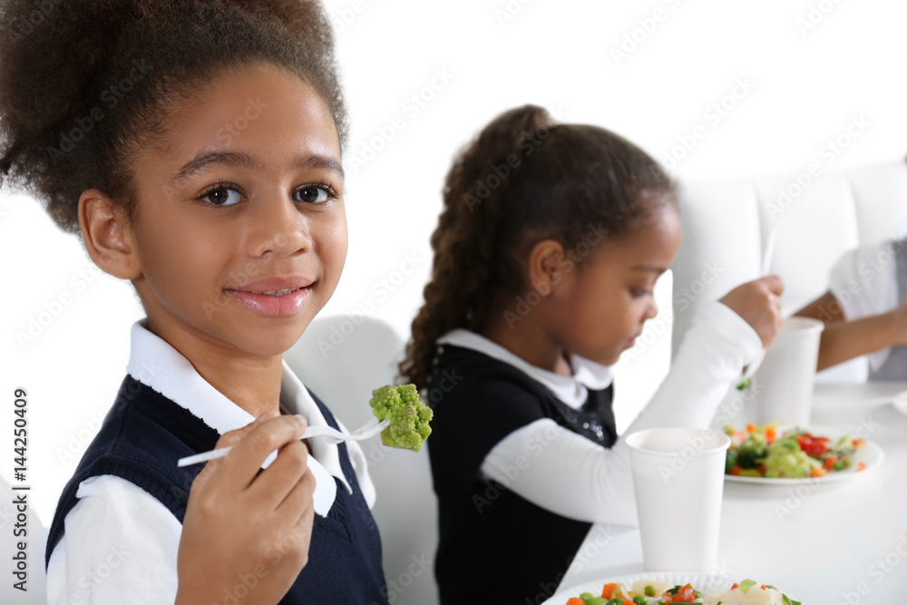 Cute African-American girls in dinning room at school Stock Photo ...