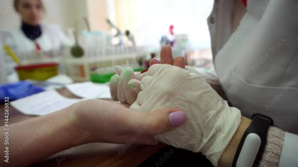 Closeup view of blood analysis from finger. Medical hand taking blood ...