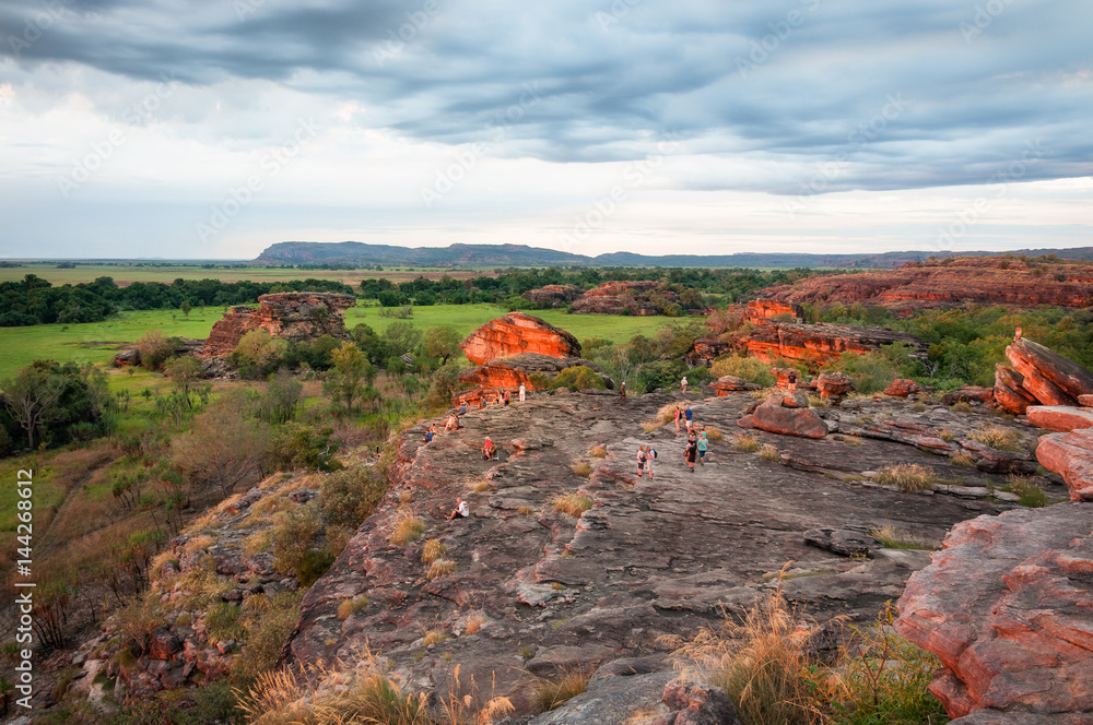Sandstone rocks glowing red in the sunset light at Ubirr Rock, Kakdu National Park, NT ...