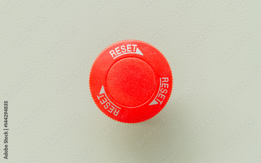 Red emergency stop and reset button on control panel for machine ...