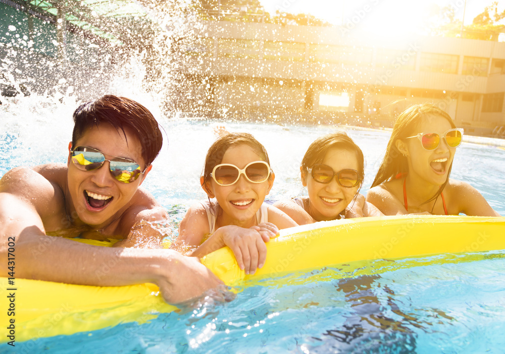 Happy family playing in swimming pool Stock Photo | Adobe Stock