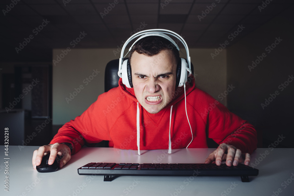 Portrait evil gamer headphones watching carefully monitor your computer ...