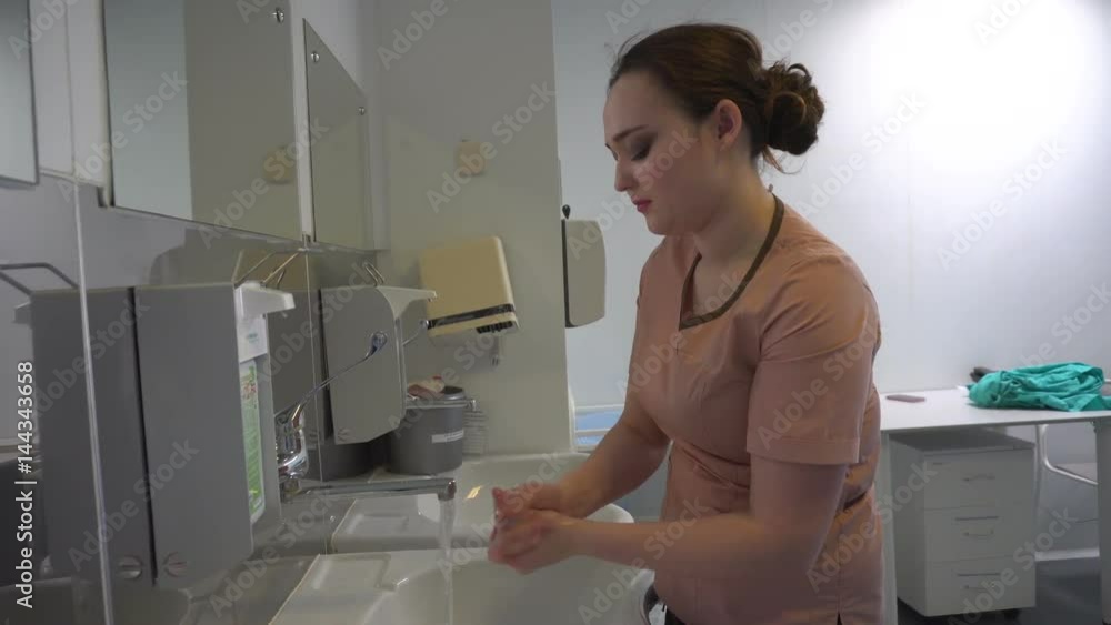 Female doctor washing his hands in a surgical washroom Stock Video ...