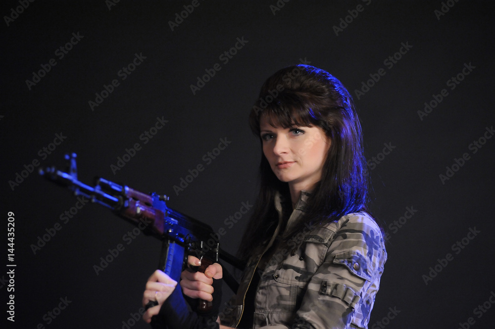 Young pretty female model with AKS-74 (Kalashnikov) assault rifle in ...