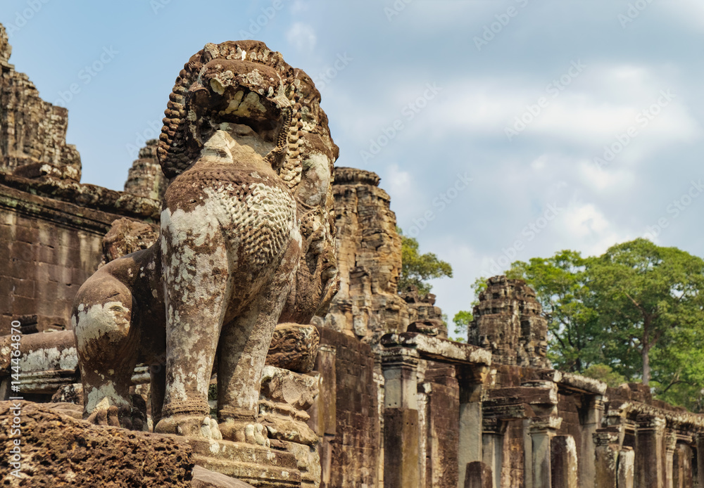 Lion in the foreground guards Prasat Bayon, central temple of Angkor ...