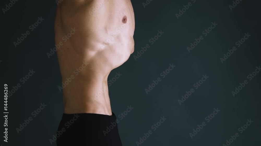 Strong bodybuilder with six pack, perfect abs showing vacuum exercise ...