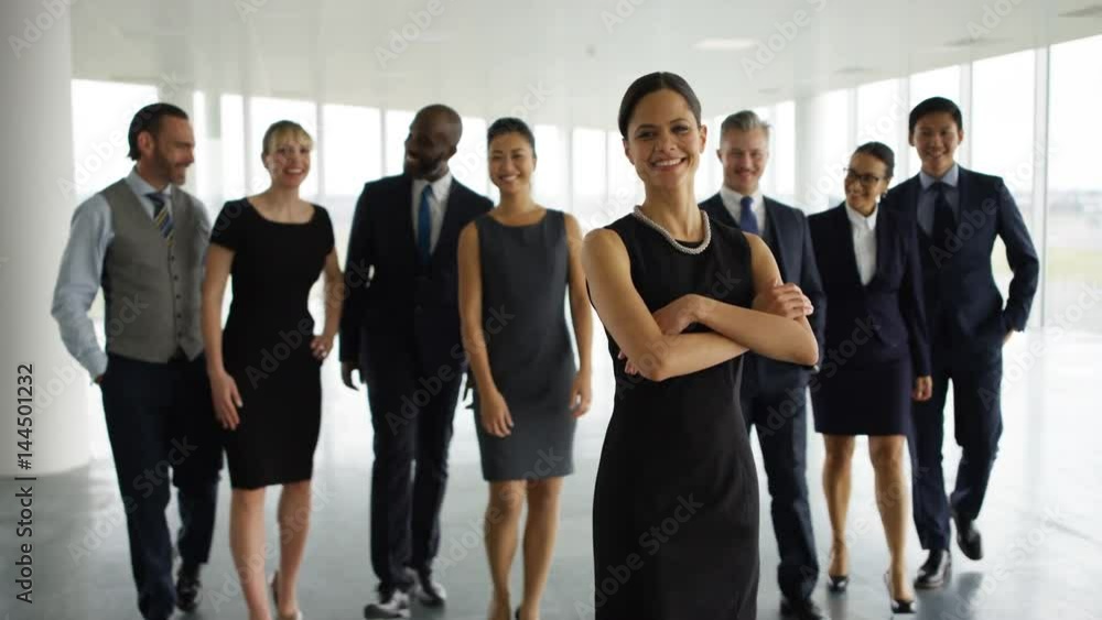 Portrait happy multiracial business team in large open plan office ...