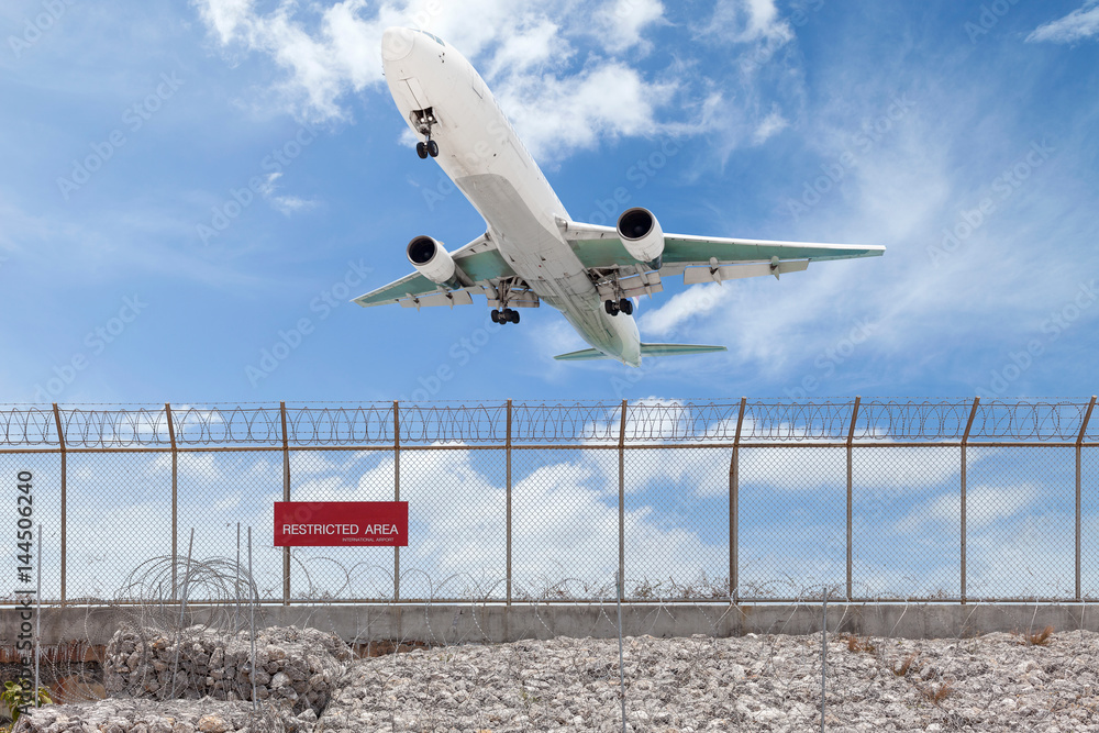 Restricted area fence and Passenger airplane landing beautiful blue sky ...