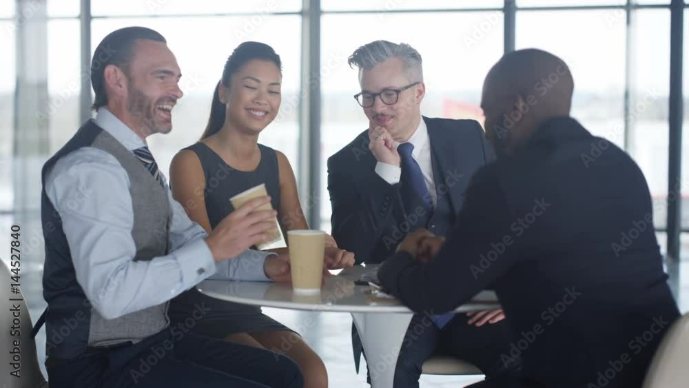 Corporate business team in informal meeting in large open plan office ...