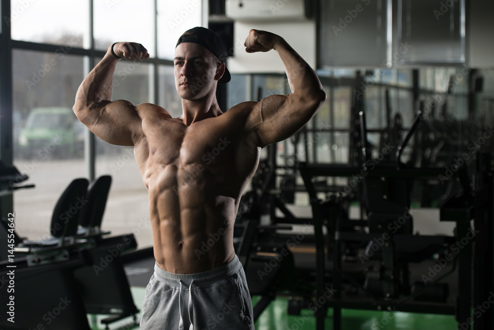 Bodybuilder Fitness Model Posing Double Biceps After Exercises Stock ...
