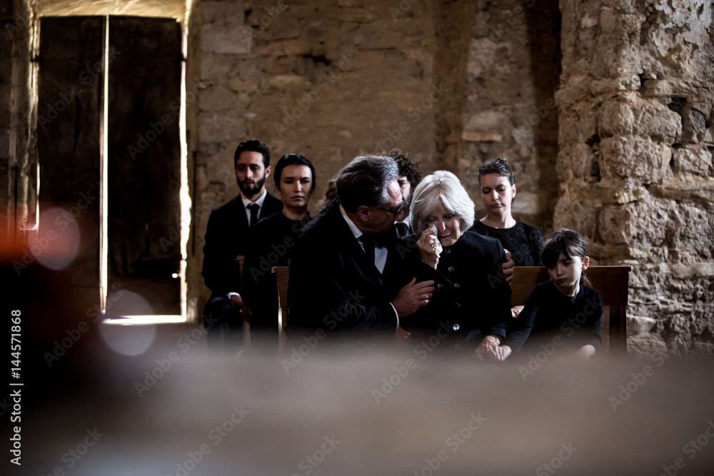 Senior woman being comforted at a funeral Stock Photo | Adobe Stock