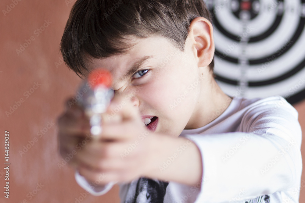 Boy taking aim with a toy gun Stock Photo | Adobe Stock
