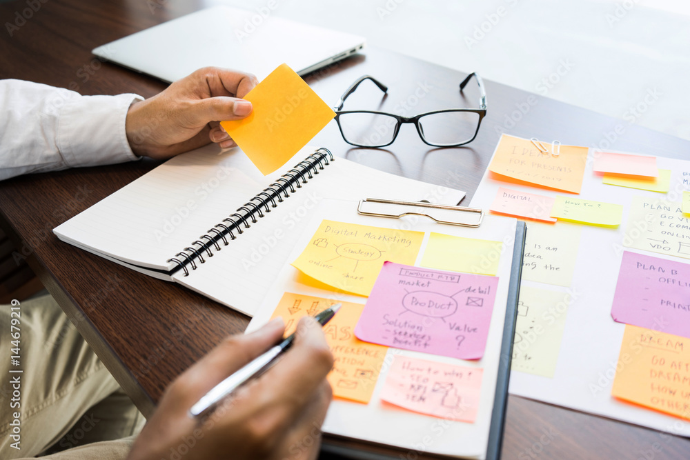 Businessman working with note paper for brainstorming ideas.strategy ...