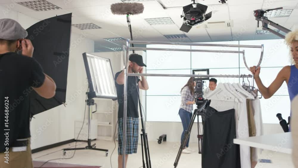 Crew member working behind the scenes on TV production set Stock Video ...