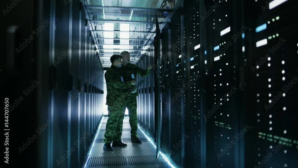 In Data Center Two Military Men Work with Open Server Rack Cabinet. One ...