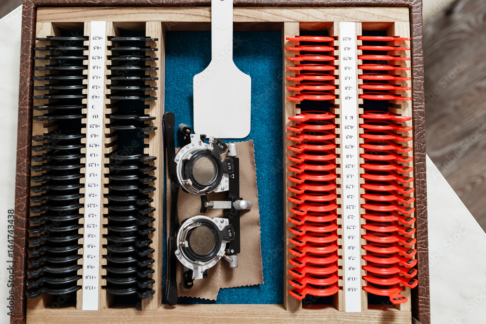 Optometrist prepares a set of ophthalmic trial lenses for vision ...