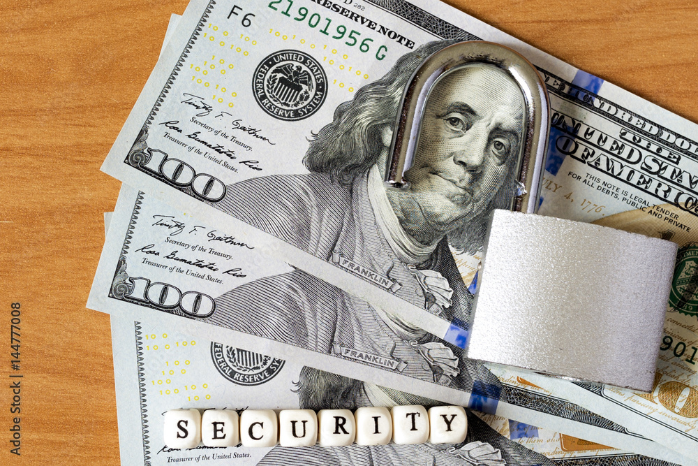 dollar currency notes with lock and chain. money stack for safety and ...
