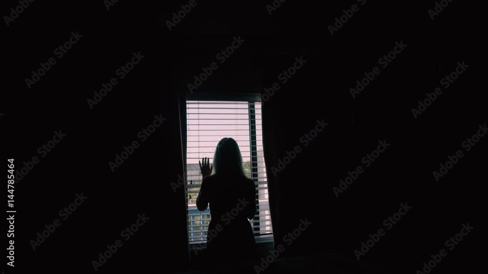 Happy teen girl relaxing at the hotel's apartments on the bed. Girl is ...