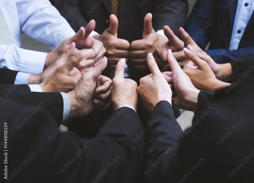 Foto de Business people holding many thumbs up together, showing power ...