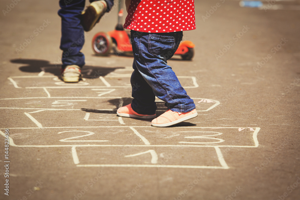 kids playing hopscotch on playground outdoors Stock Photo | Adobe Stock
