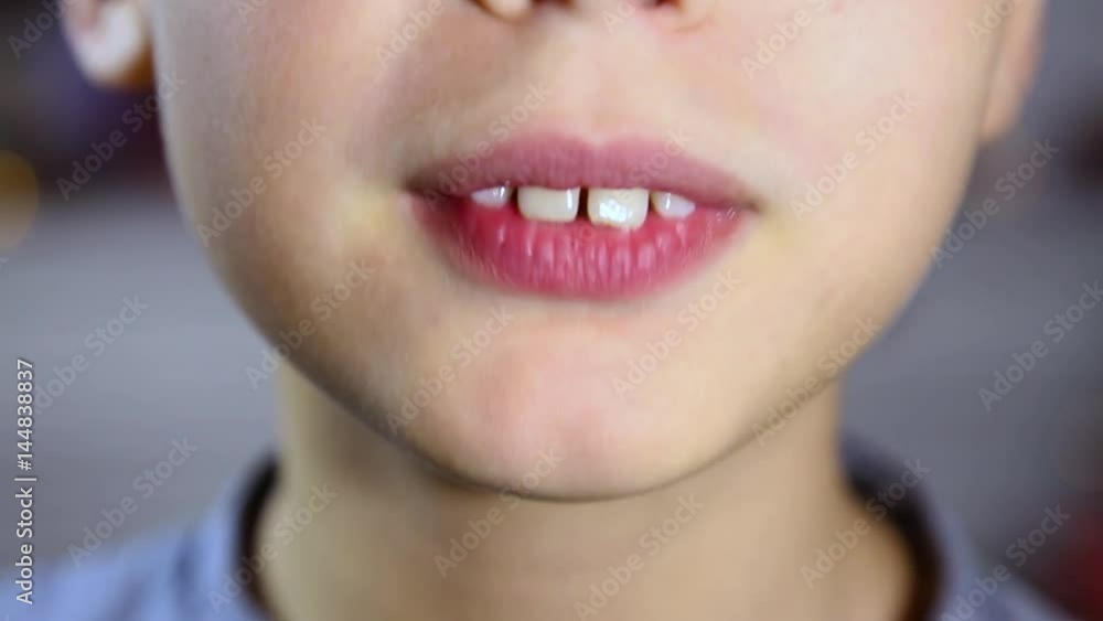 Cute child singing song before camera. Closeup of mouth and moving lips ...