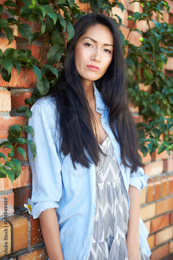 Young mixed race Asian woman with serious expression Stock Photo ...