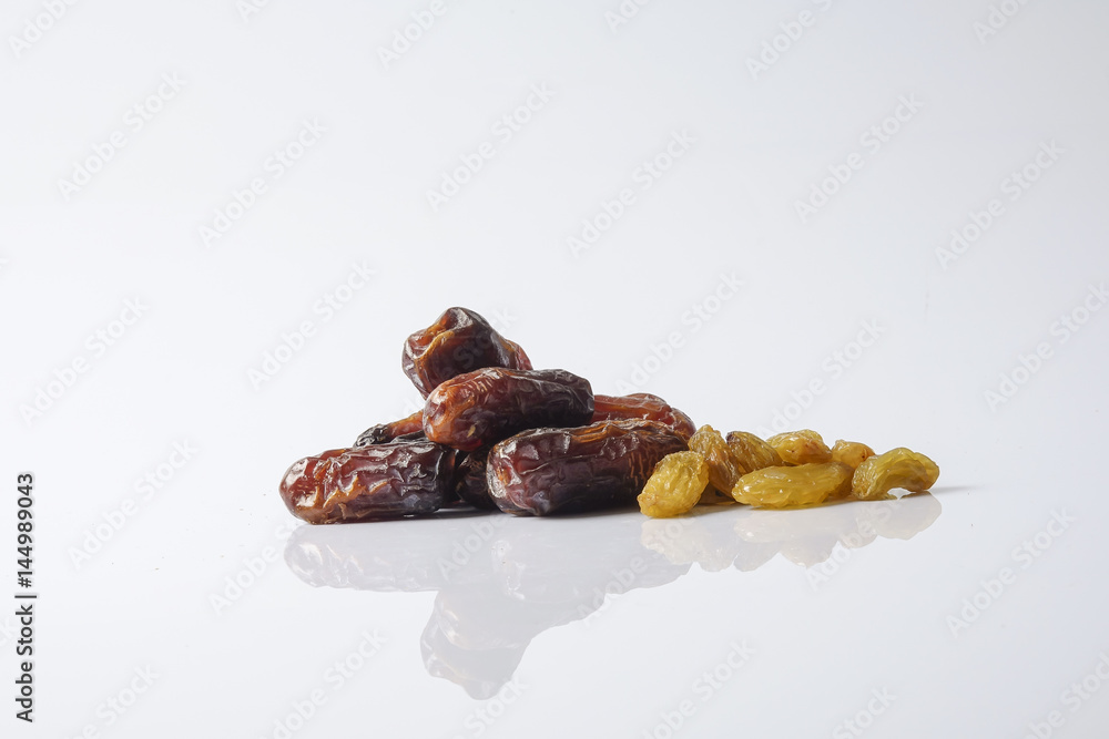 Dates and raisin isolated on white. Stock-Foto | Adobe Stock