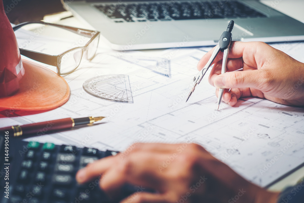 Architect or engineer working in office on blueprint. Architects ...