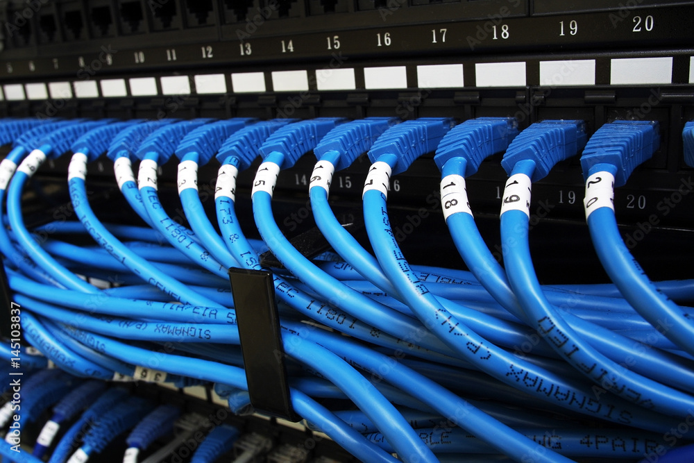Network cable and switch in server room with empty space for labels ...