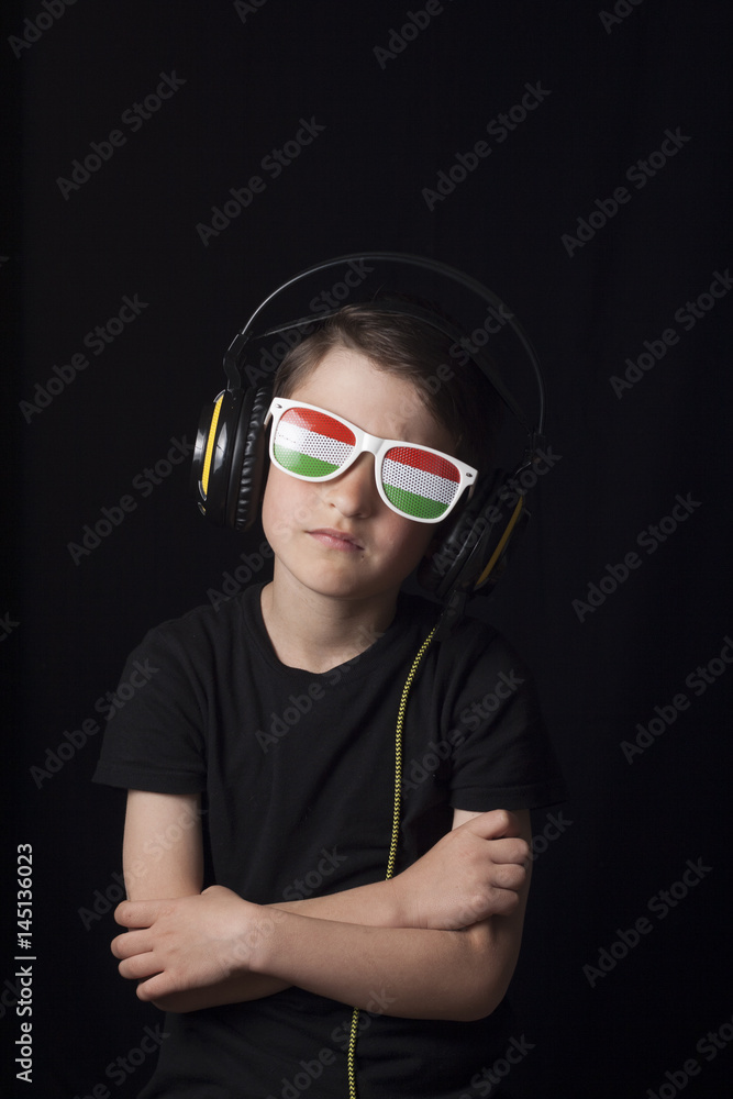 Foto de Low key portrait of young boy isolated on black background ...