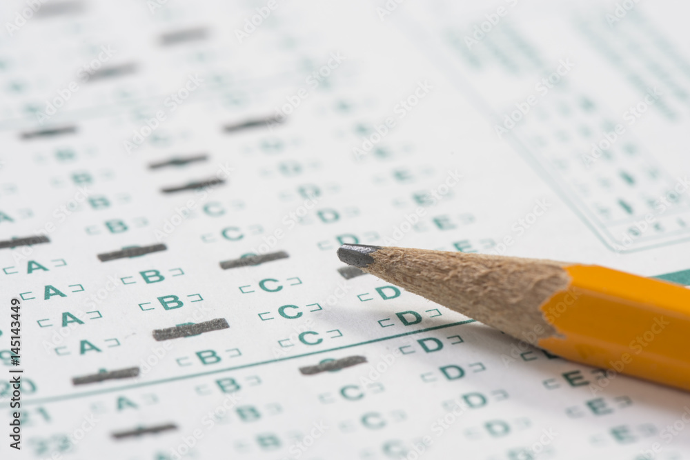 Close up of a standardized test form with a pencil resting on it with a ...