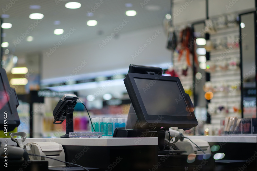 Cash desk with large screen and card payment terminal in modern store ...