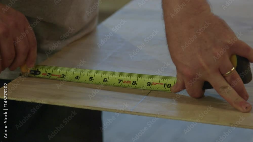 Carpenter Using Measuring Tape to Mark Section of Plywood Stock Video ...