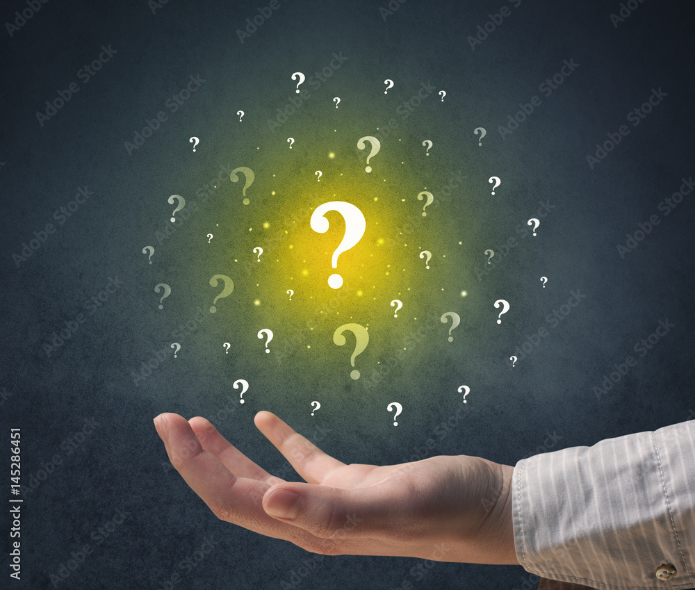 Hand holding question marks Stock Photo | Adobe Stock