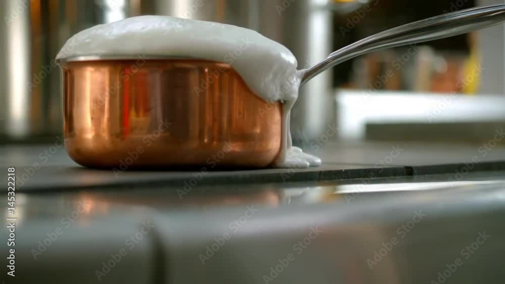 boiling milk/on a gas stove boiling milk in a saucepan on the stove and ...
