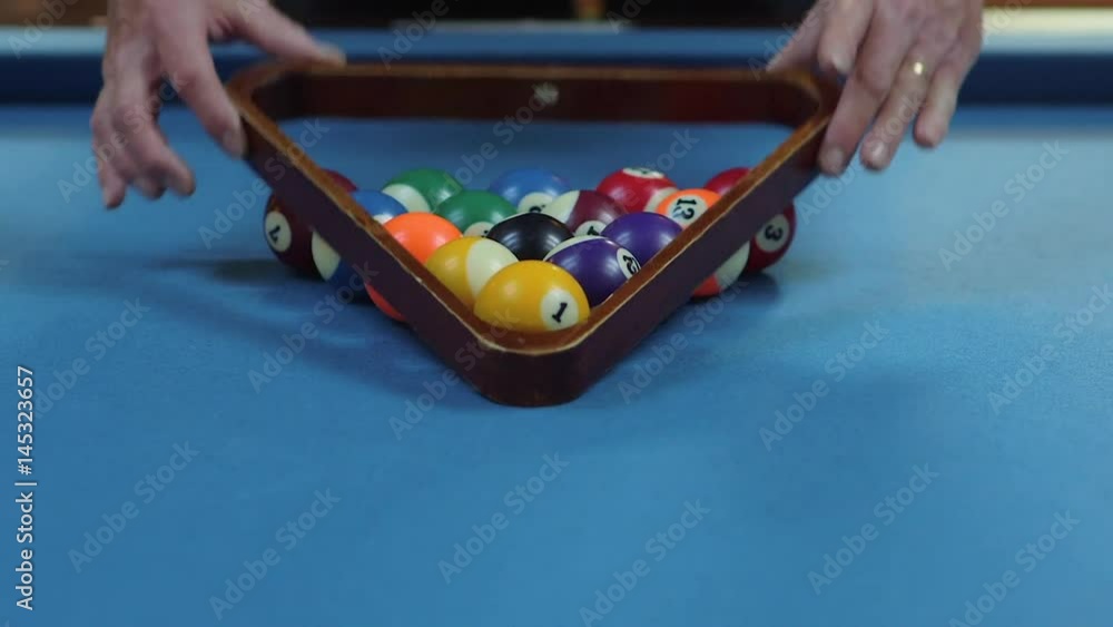 Man Racking Pool Balls in Eight-Ball Formation on Blue Billiards Table ...