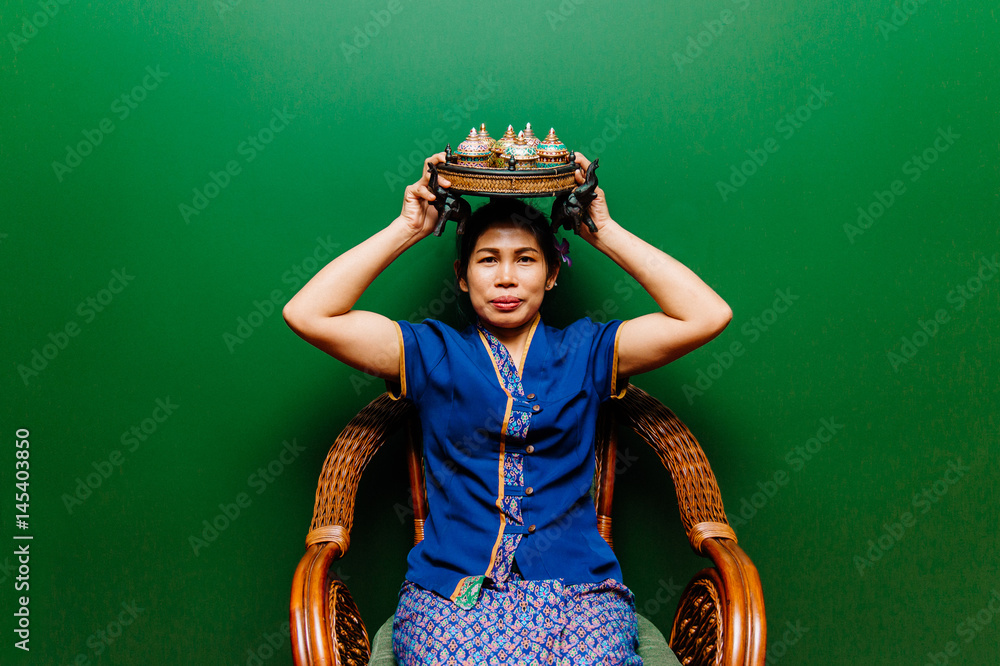 Thai spa masseur worker woman portrait with antique benjarong ceramic ...