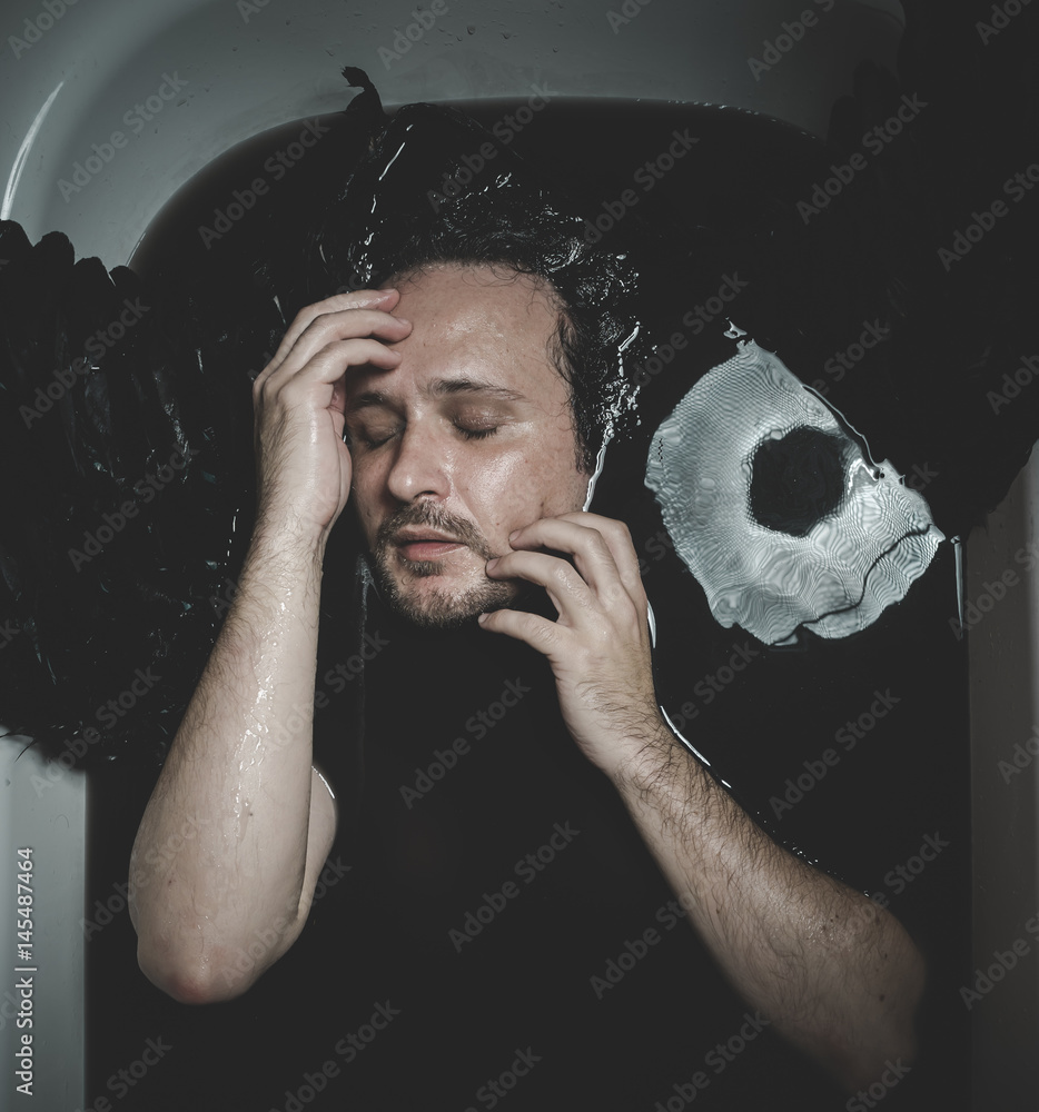 Satan, Fallen angel, man in a bathtub with black water and wings ...